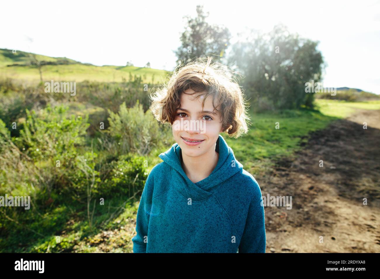 Girl with braces smiles while outside on a nature trail Stock Photo - Alamy