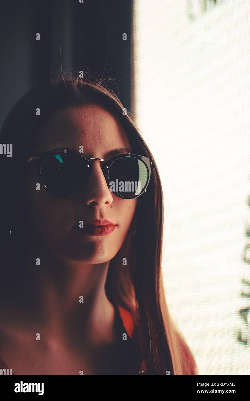 Girl next to neon light reflecting in her face Stock Photo - Alamy