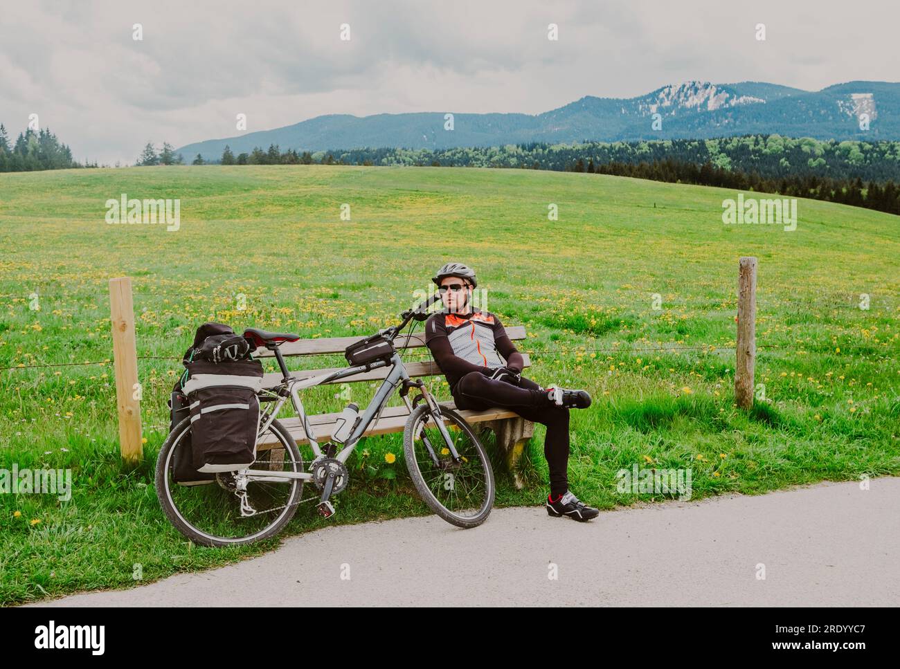 A cyclist rest with The Alps in the back Stock Photo - Alamy