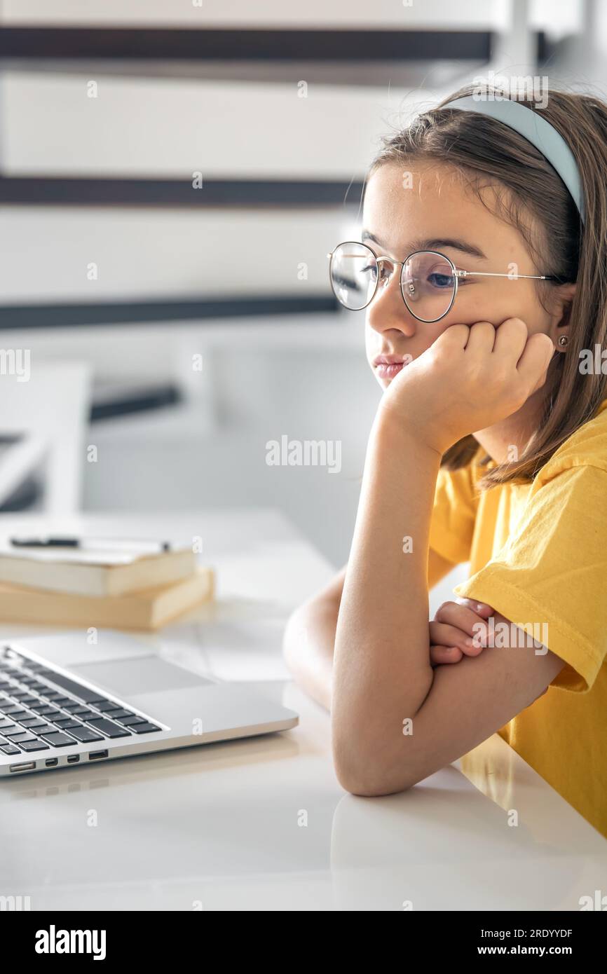 Exhausted schooler girl suffering from doing homework, tired from ...