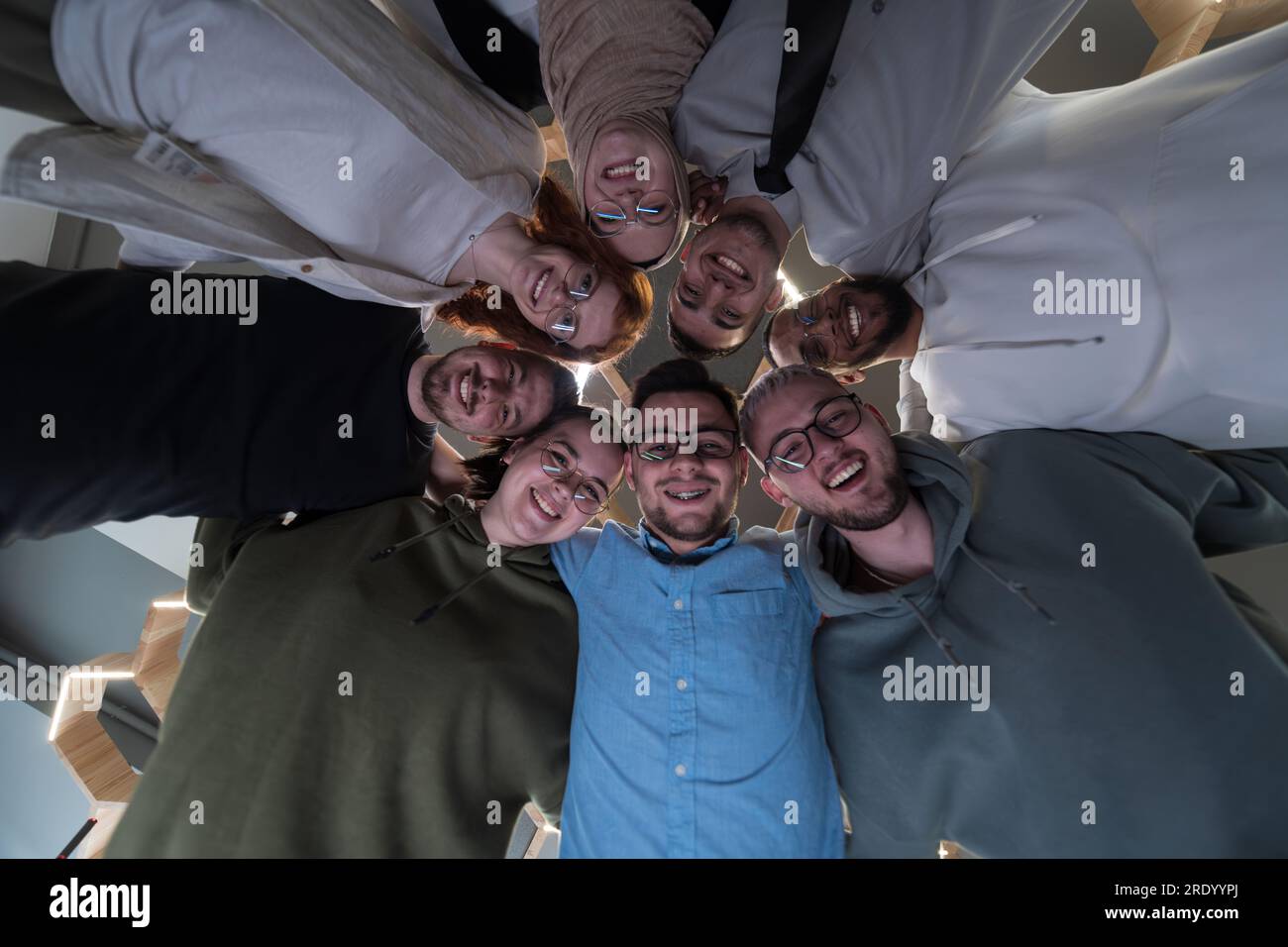 In a modern office, a group of young business professionals is captured ...