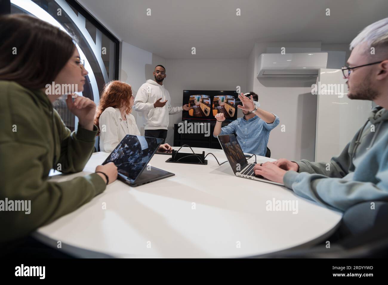 A diverse group of businessmen collaborates and tests a new virtual ...