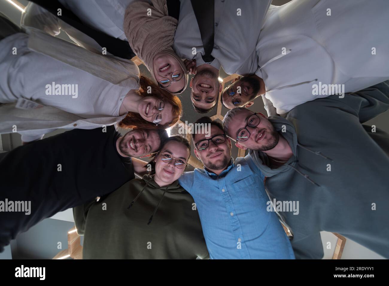 In a modern office, a group of young business professionals is captured ...