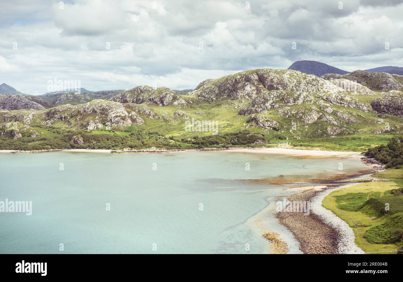 Beautiful blue ocean and round rocky mountains coast in Scotland Stock ...