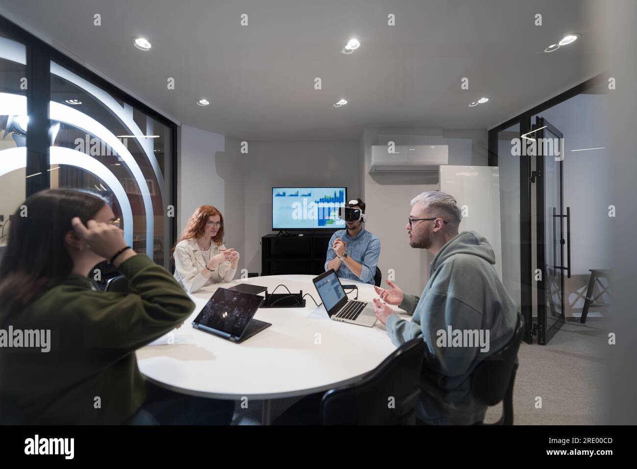 A diverse group of businessmen collaborates and tests a new virtual ...