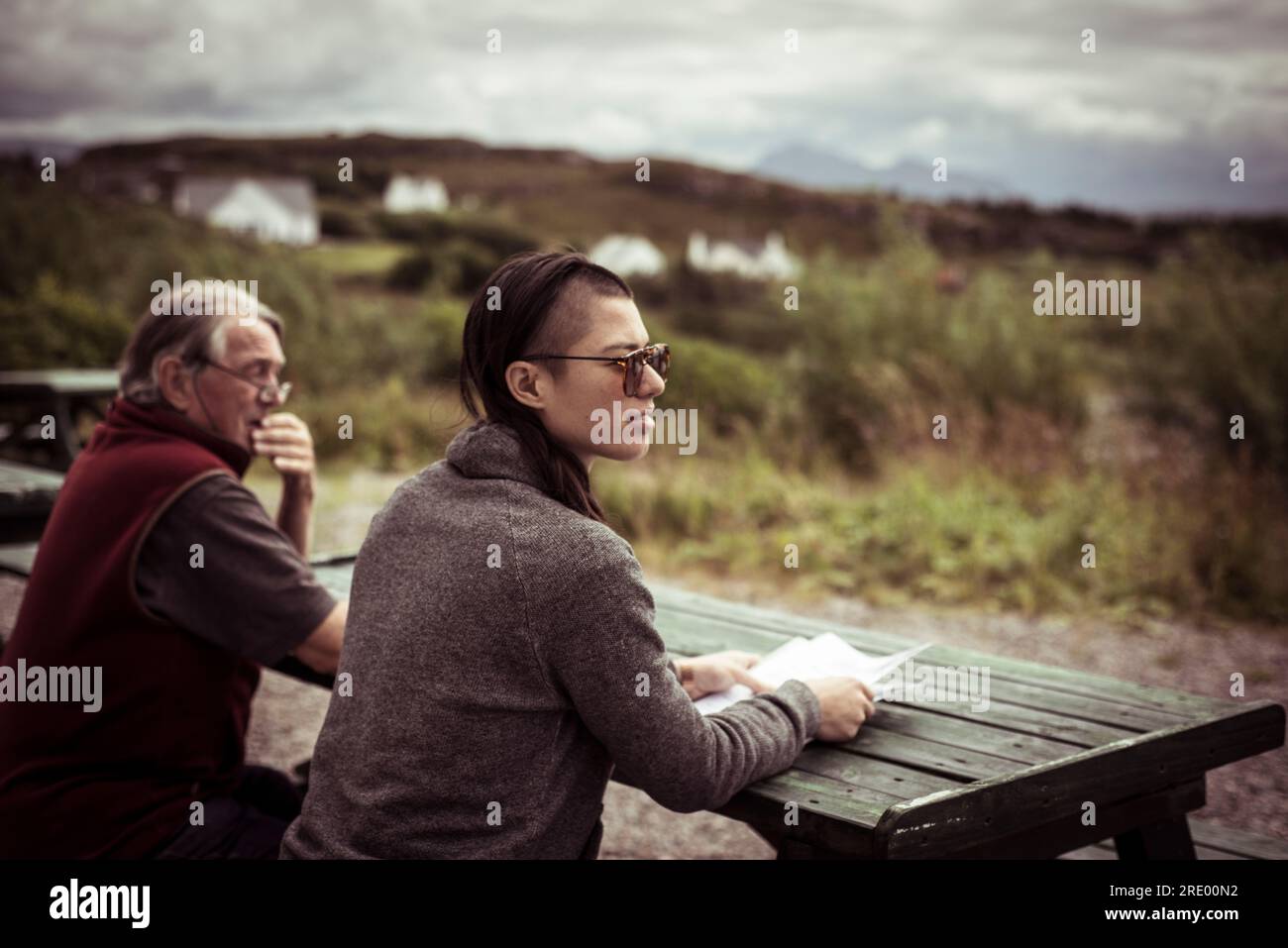 two people look out at view of mountains in scotland Stock Photo - Alamy