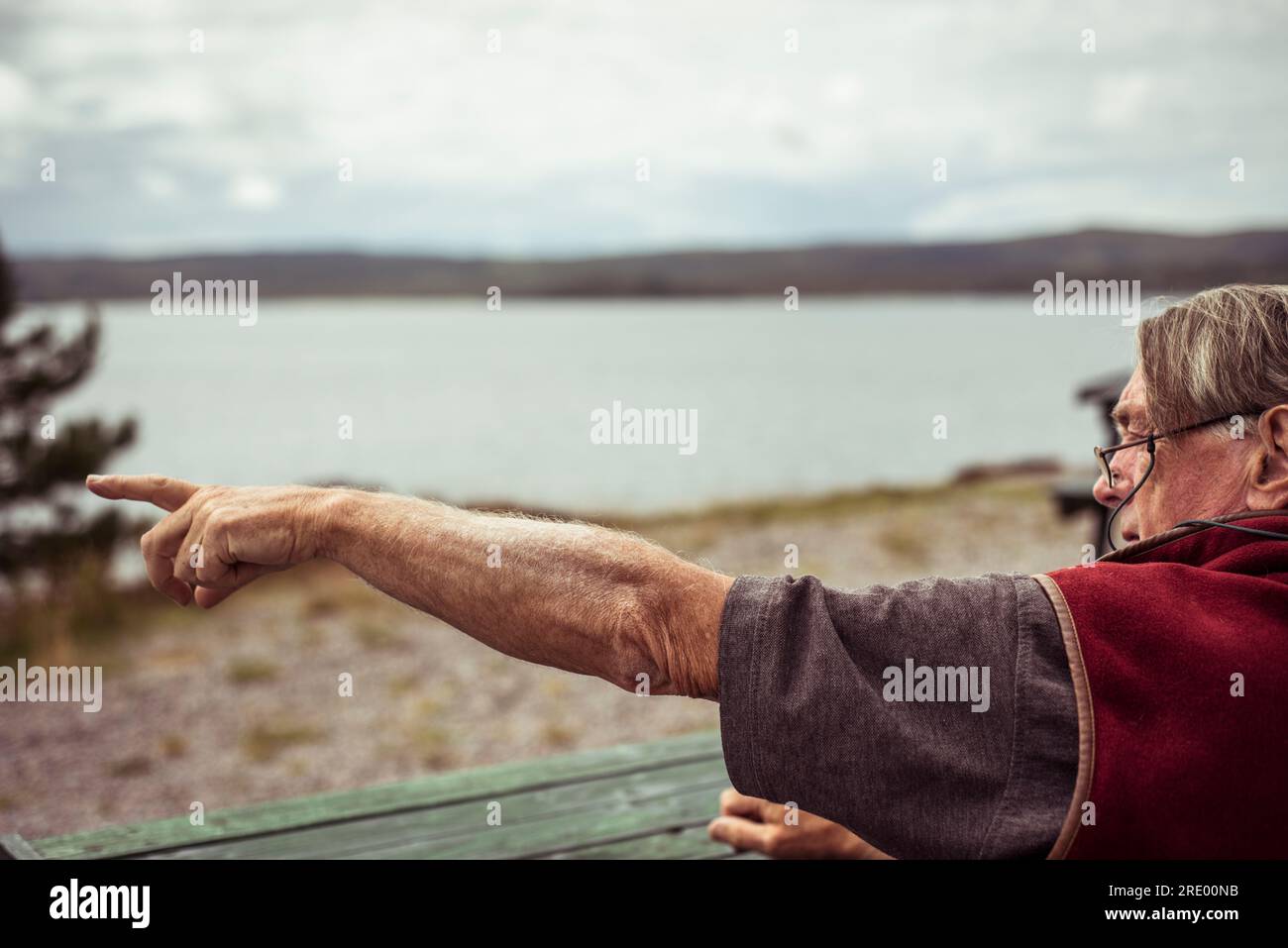 Older man points at mountain Stock Photo - Alamy