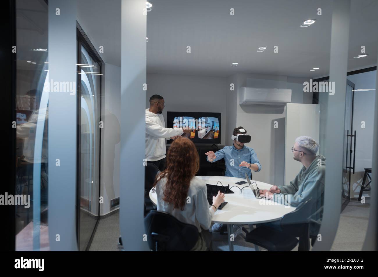 A diverse group of businessmen collaborates and tests a new virtual ...