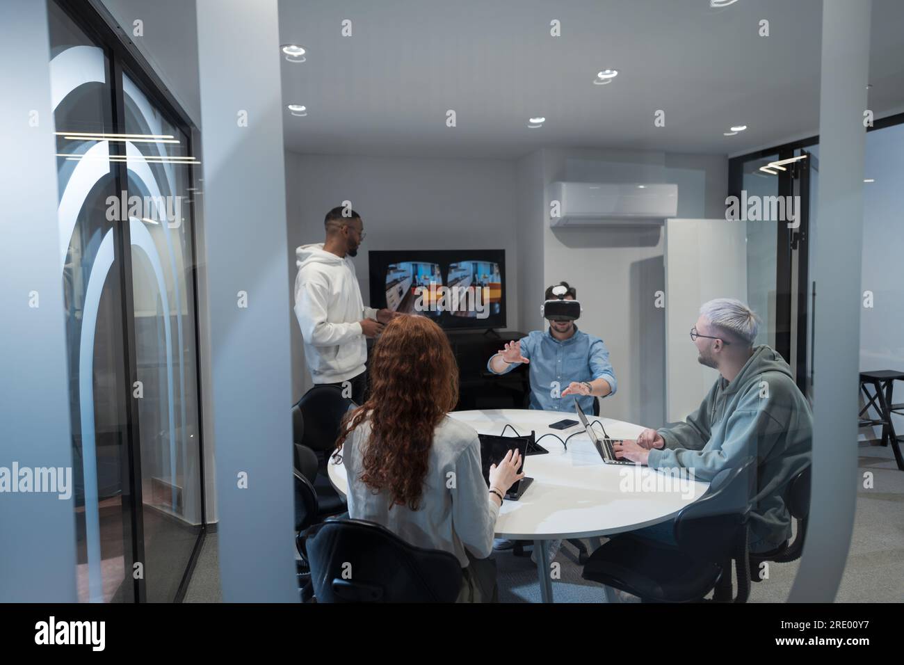 A diverse group of businessmen collaborates and tests a new virtual ...