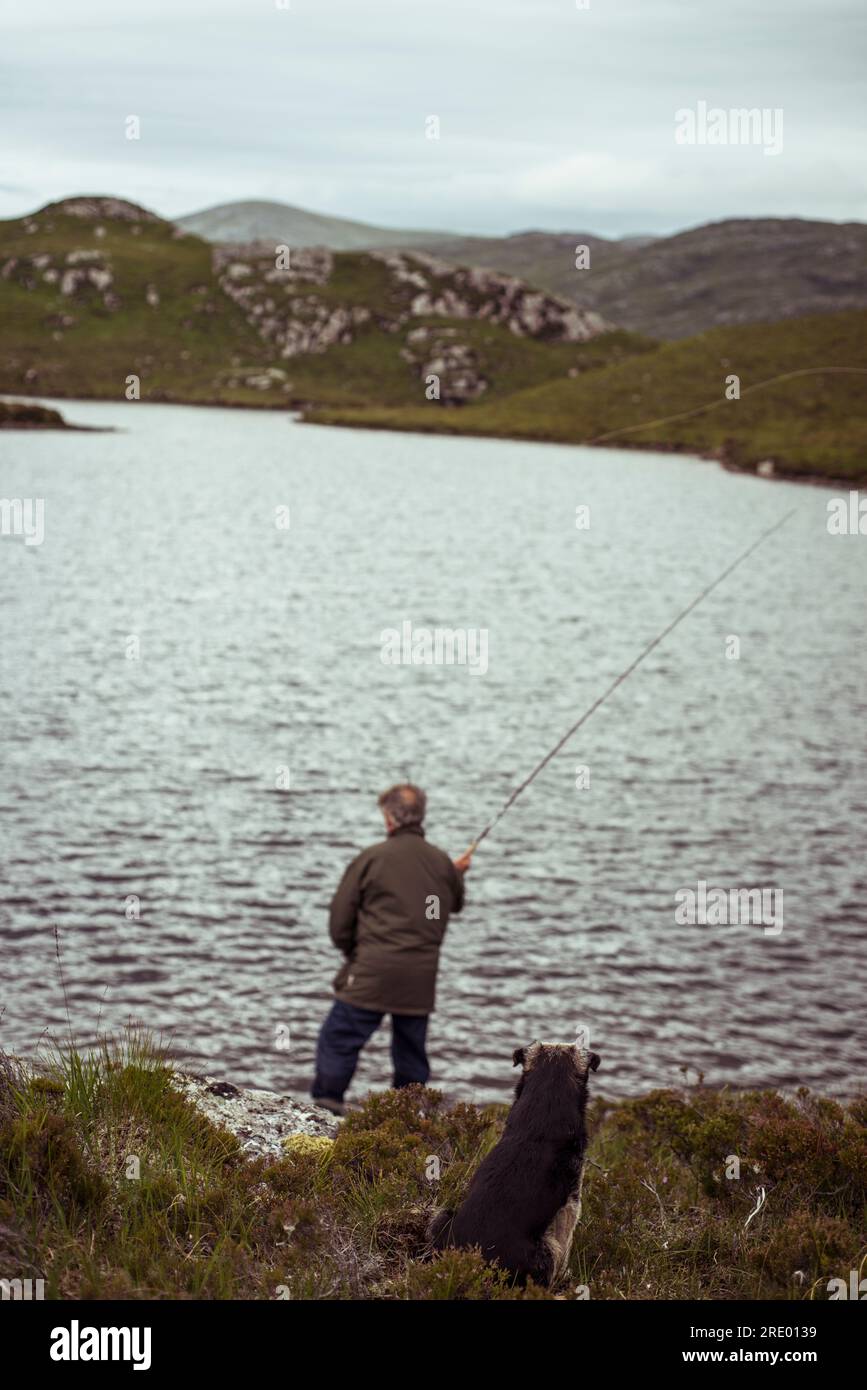 Man and dog fishing hi-res stock photography and images - Alamy