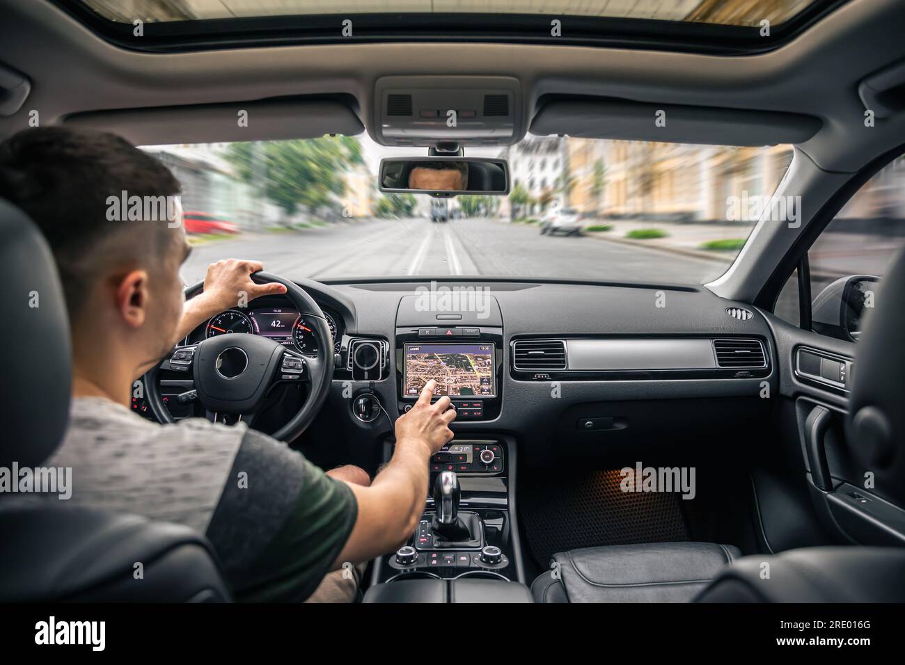 Man touching screen of a GPS navigation system in his car Stock Photo ...