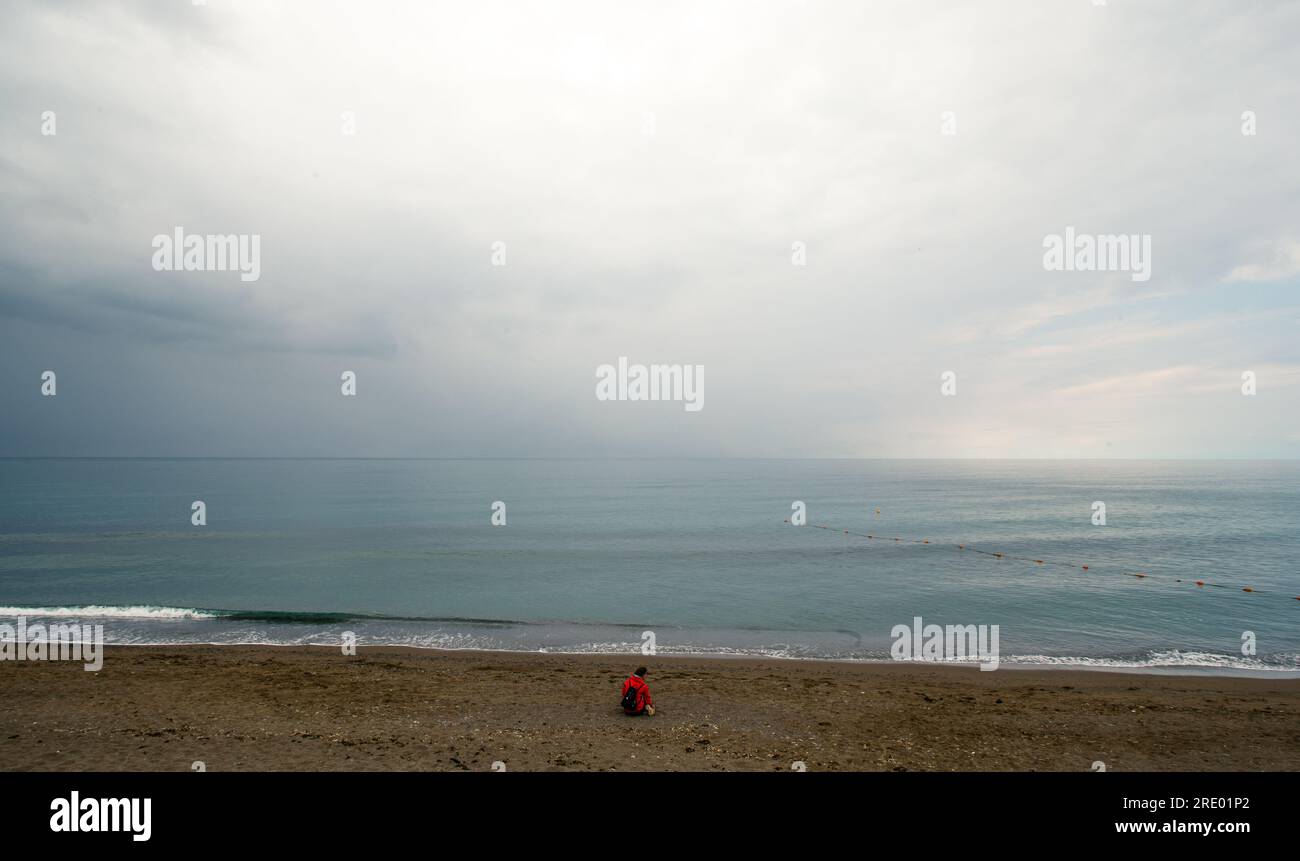 lonely Girl on the beach in sea Stock Photo - Alamy