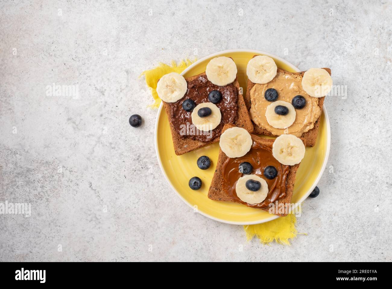 Breakfast toasts with nut butter, banana and blueberry with cute funny ...