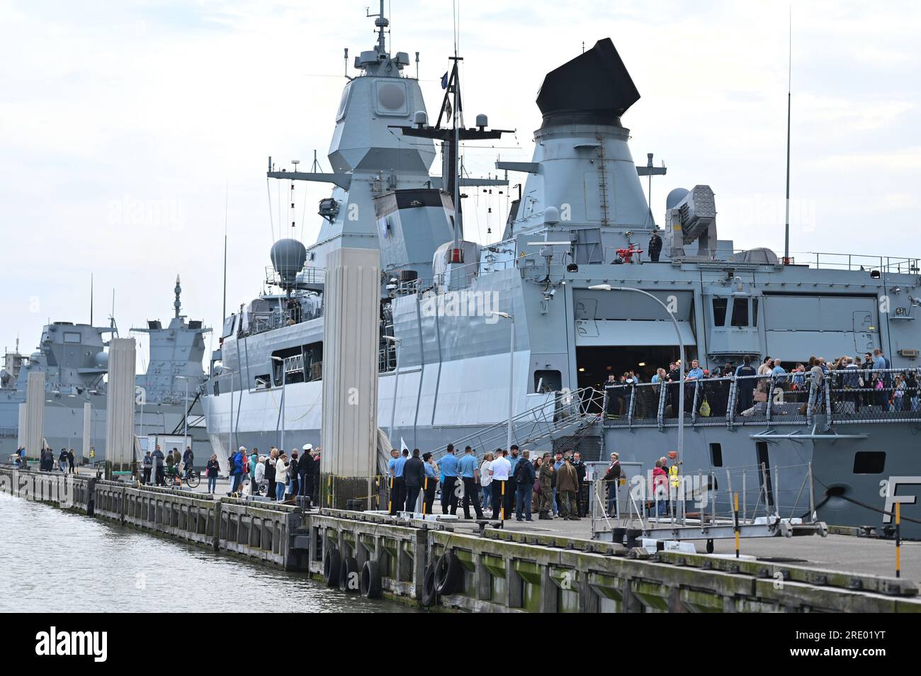 24 July 2023, Lower Saxony, Wilhelmshaven: Members of the crew stand on ...