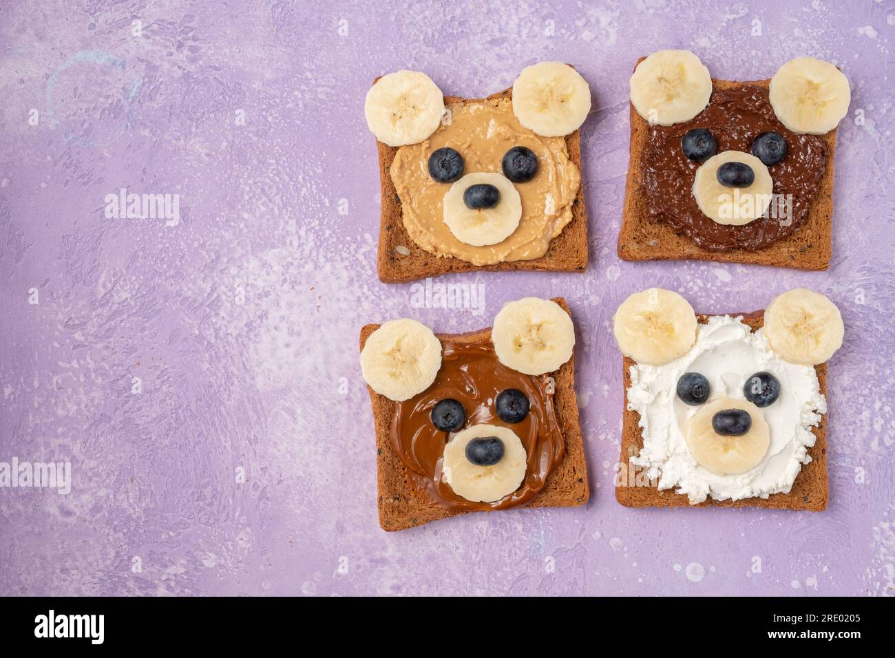 Breakfast toasts with nut butter, banana and blueberry with cute funny ...