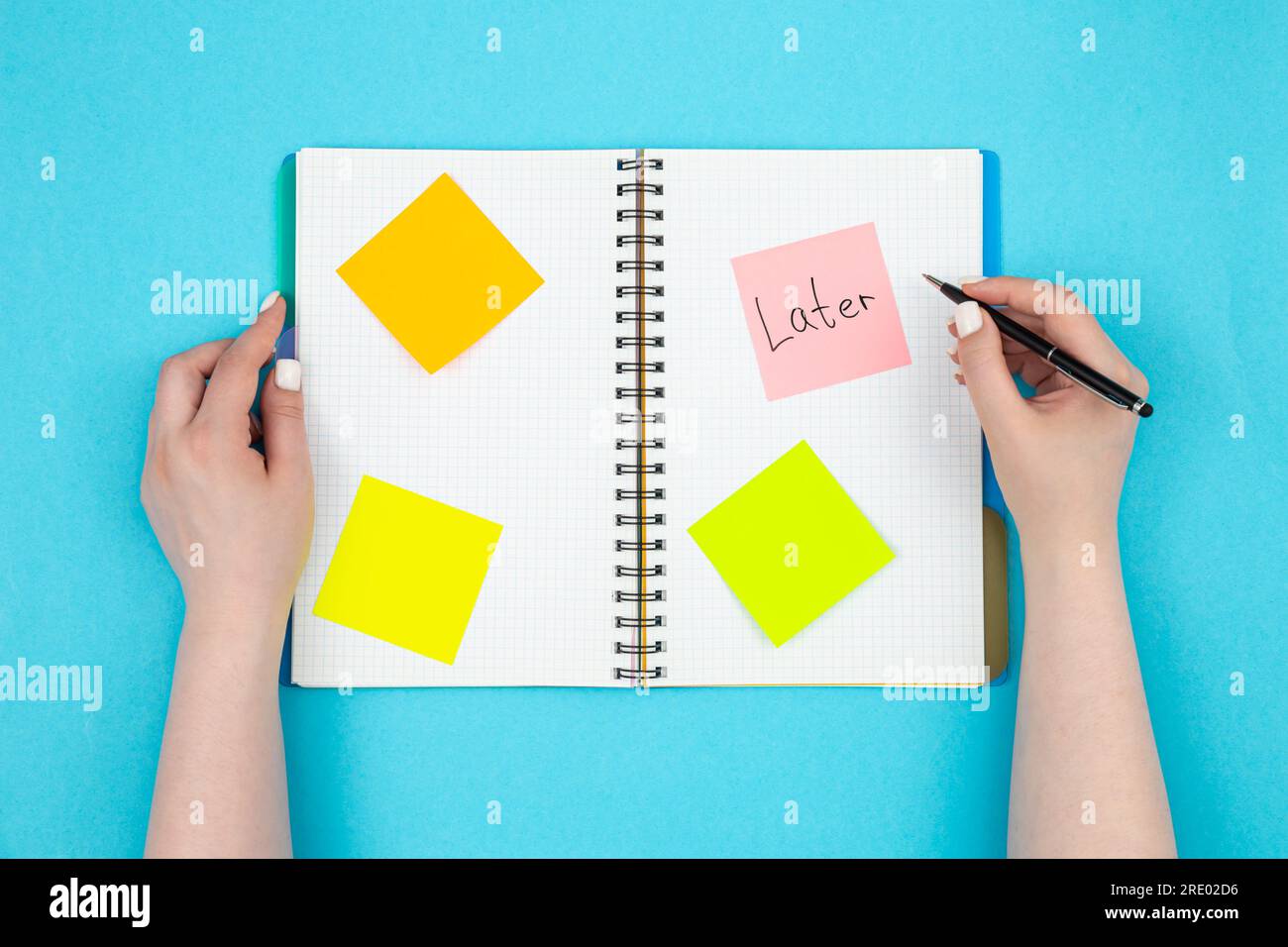 The woman wrote the word Late on a paper reminder in a notepad Stock ...