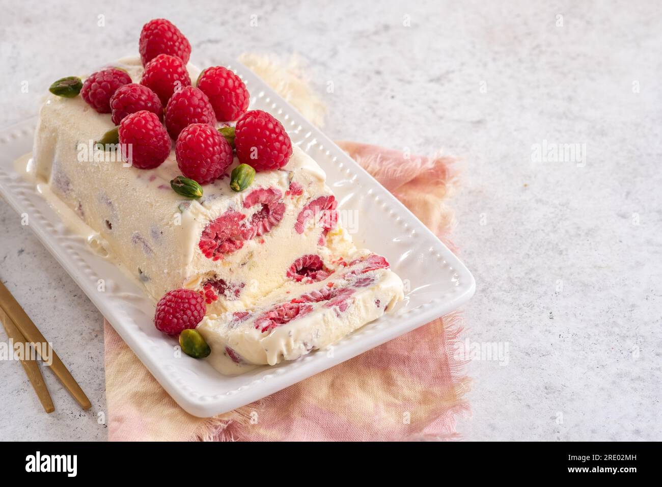 semifreddo, italian ice cream dessert, with raspberry and pistachios ...