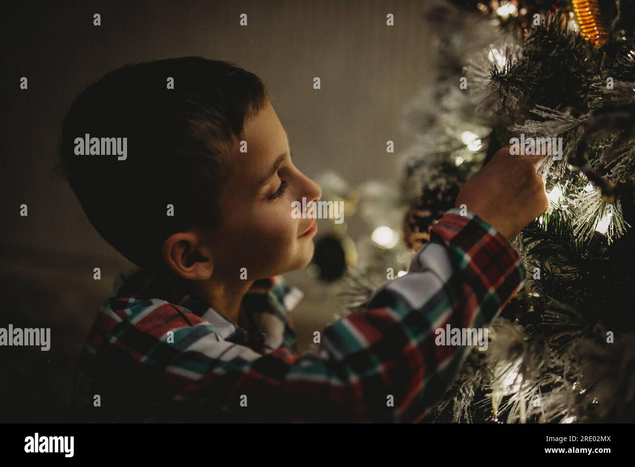 Boy by the christmas tree hi-res stock photography and images - Alamy
