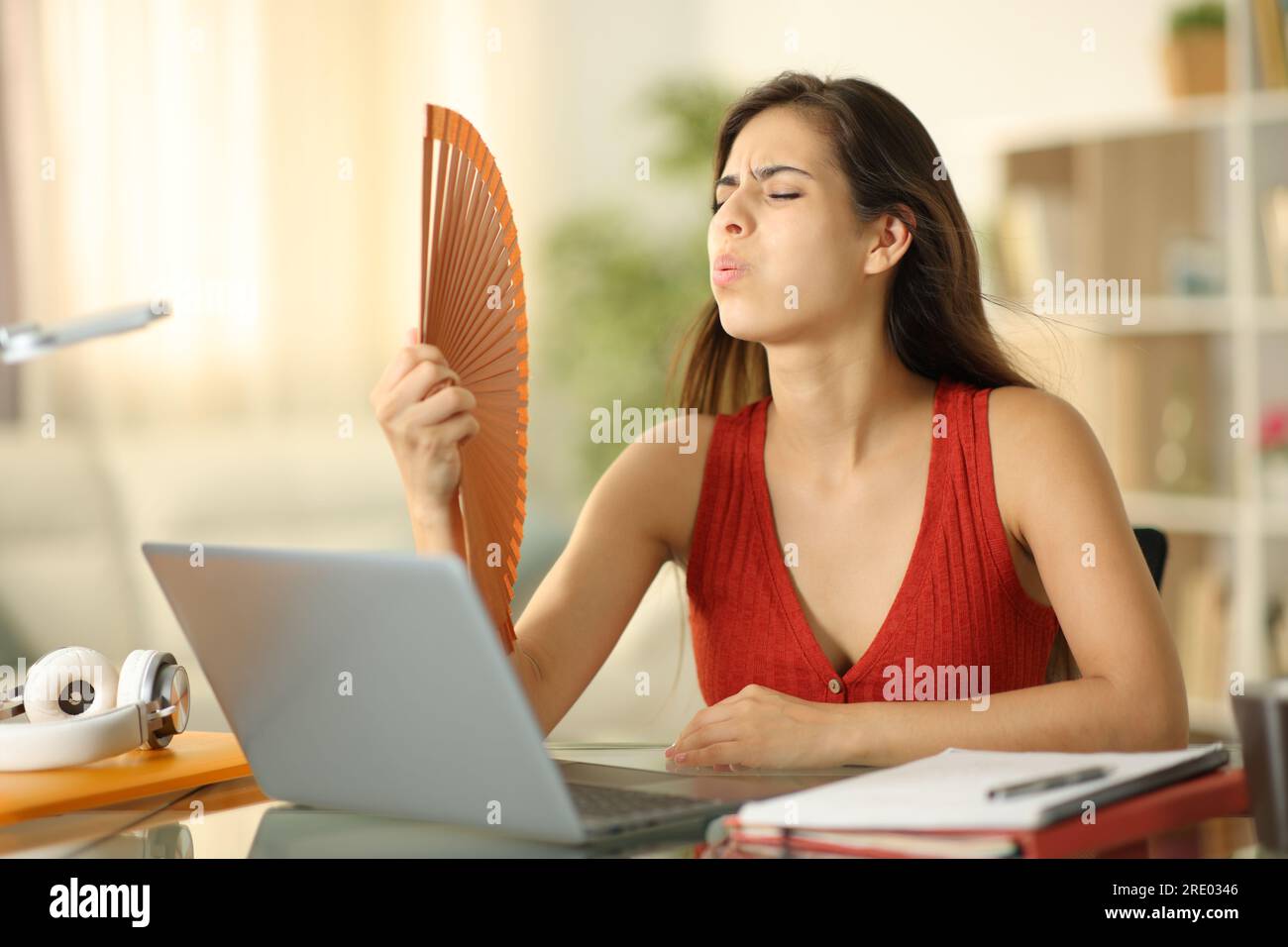 Stressed student at home suffering heat stroke and fanning Stock Photo ...