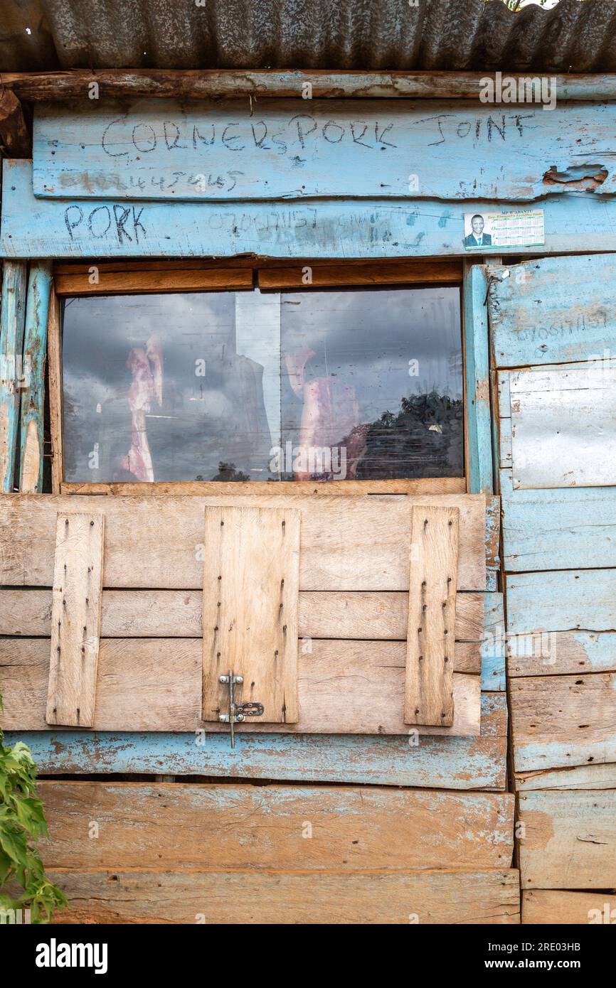 Shopwindow of a wooden hut serving as a butcher's shop. Entebbe, Uganda ...