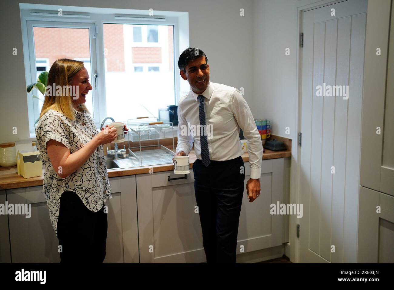 Prime Minister Rishi Sunak speaks with homeowner Jennifer Norton, as he ...