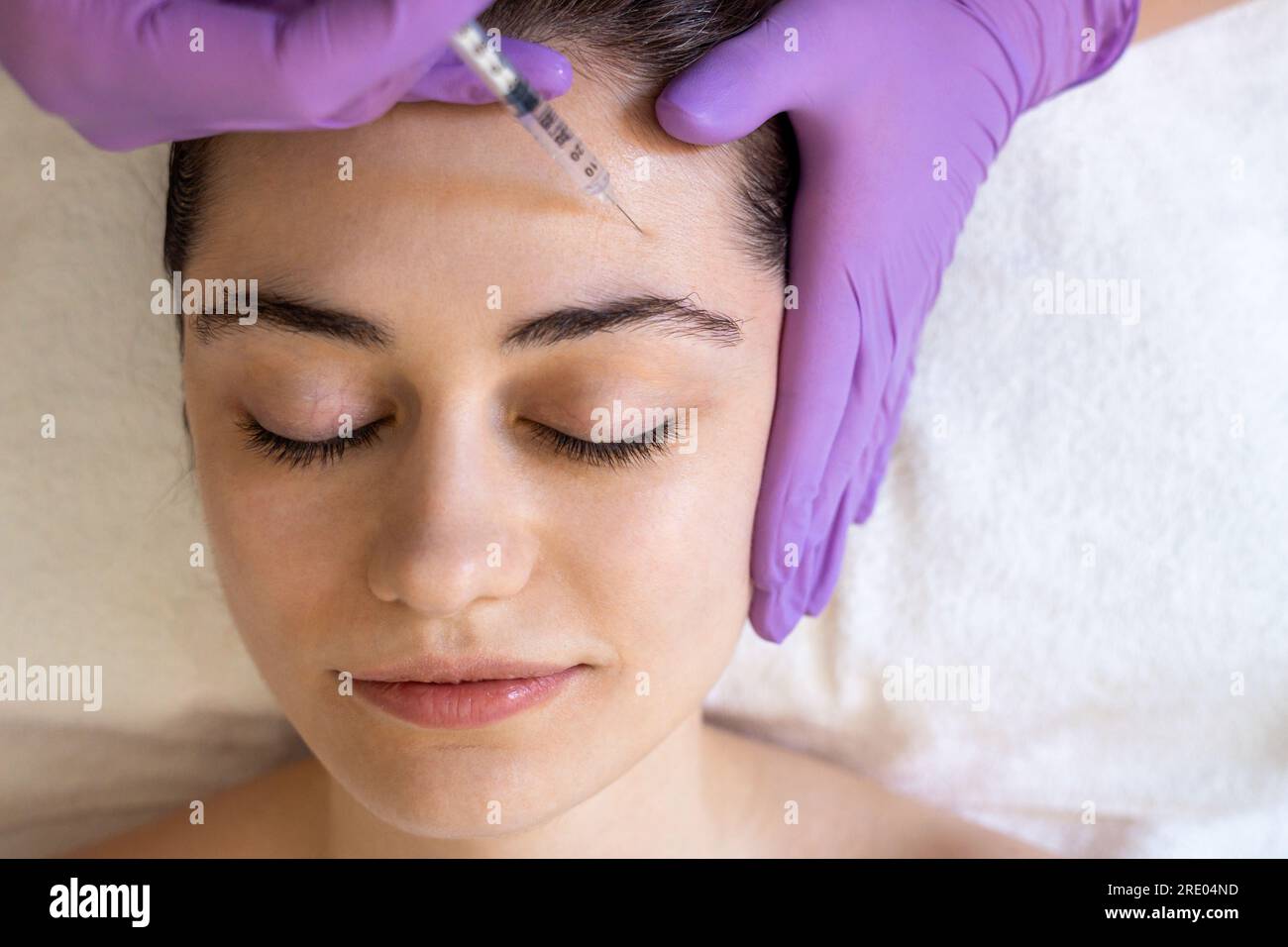 Beautiful young woman getting cosmetology treatment facial skin ...