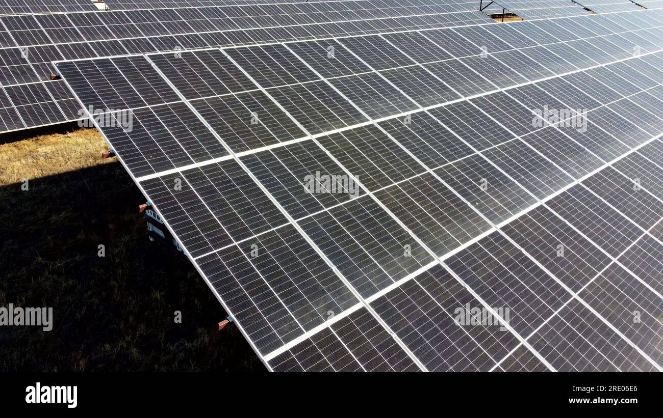 Solar power plant. Flight over modules of solar power station on sunny ...