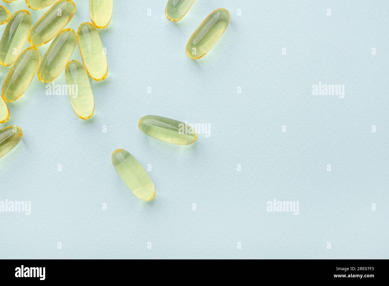 Omega 3 fish liver oil capsules on blue background Stock Photo - Alamy