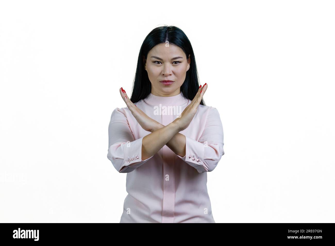 Young asian woman showing stop gesture with crossed hands. Serious ...