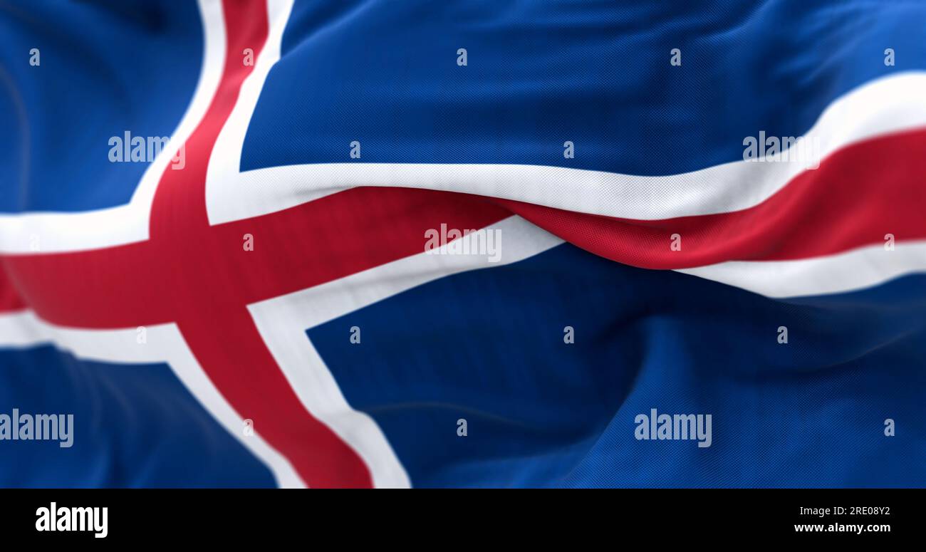 Close-up of Iceland national flag waving. Blue with a white cross and a ...