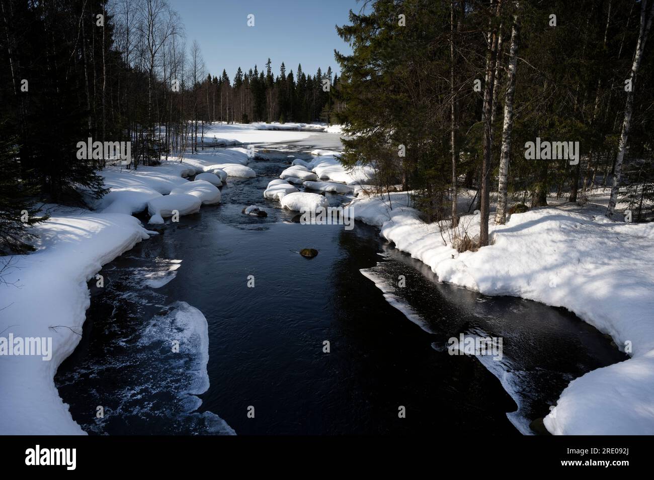 A frozen stream in the Boreal forest at Kuikka near the Russian border ...