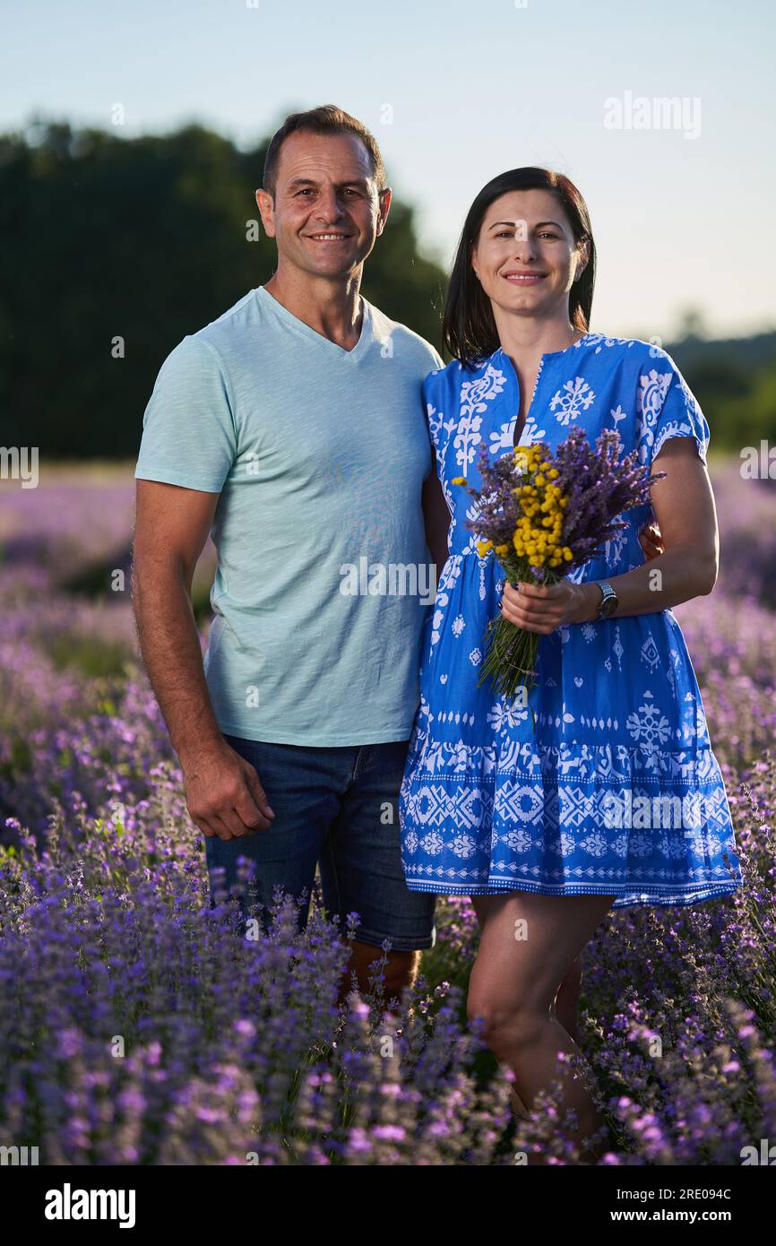 Romantic couple having a fragrant moment in a blooming lavender ...