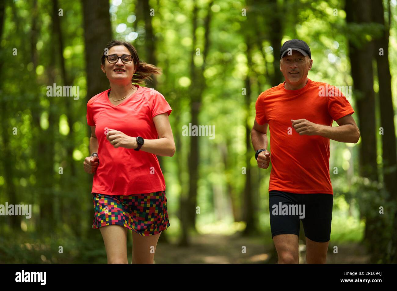 Runners couple endurance running on forest trails Stock Photo - Alamy