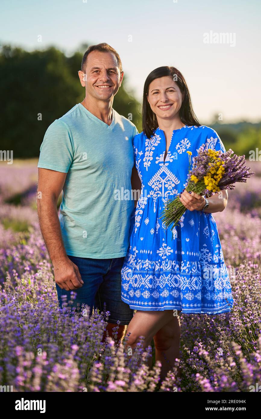 Romantic couple having a fragrant moment in a blooming lavender ...