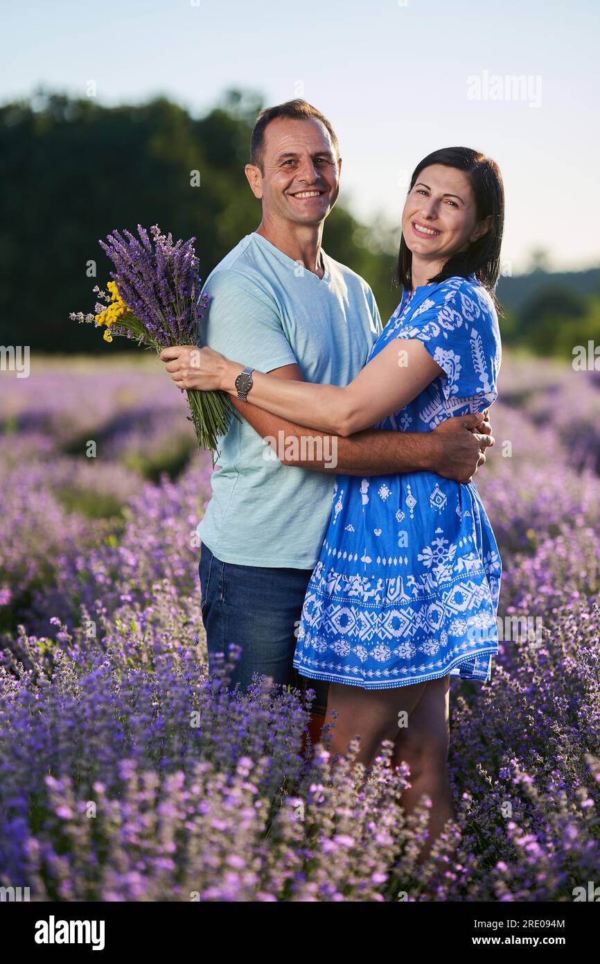 Romantic couple having a fragrant moment in a blooming lavender ...