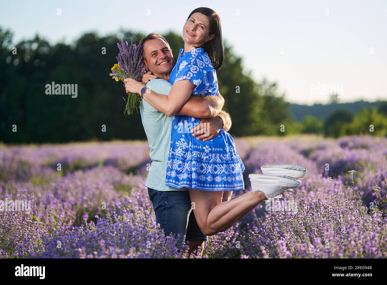 Romantic couple having a fragrant moment in a blooming lavender ...