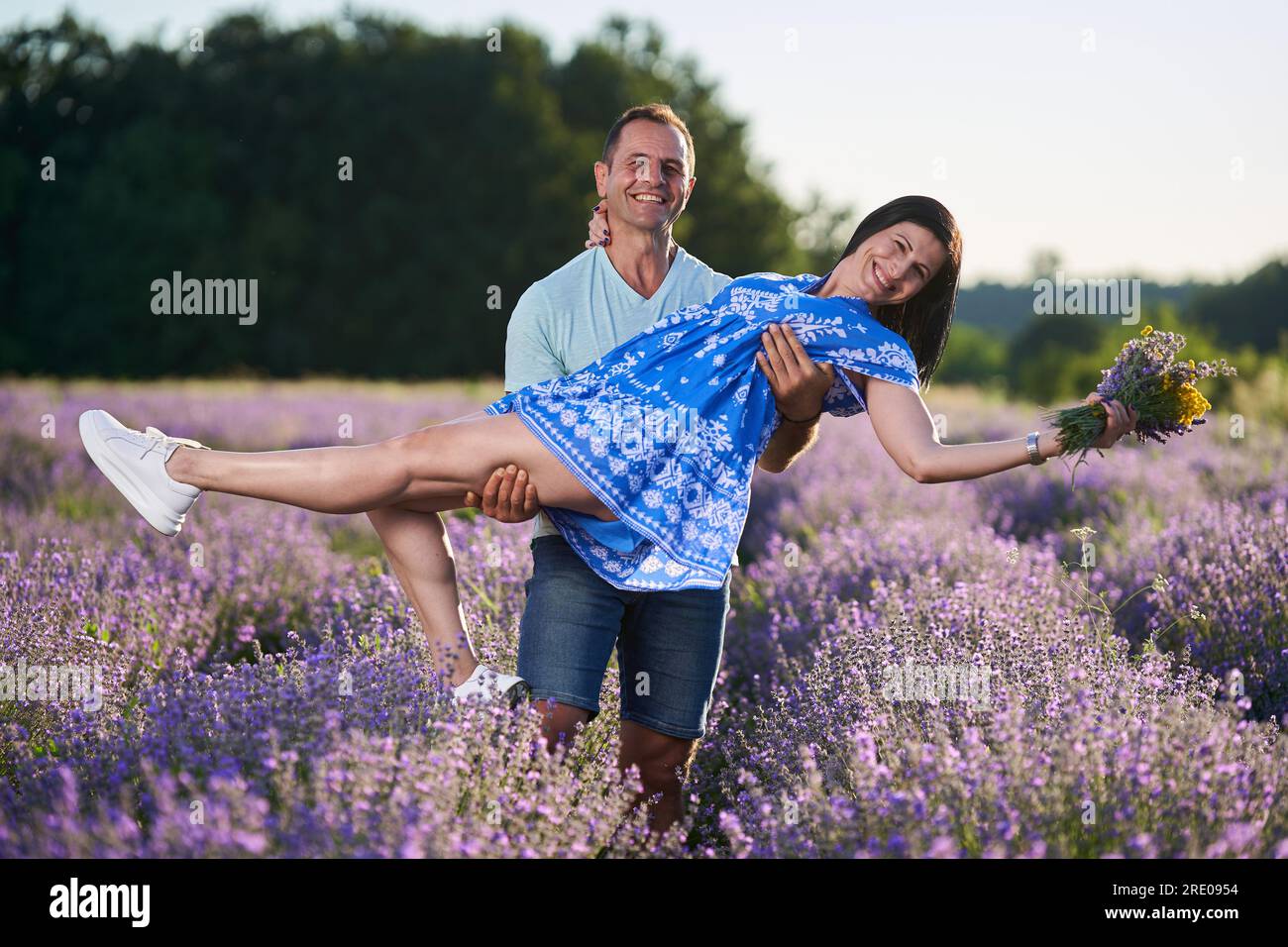 Romantic couple having a fragrant moment in a blooming lavender ...
