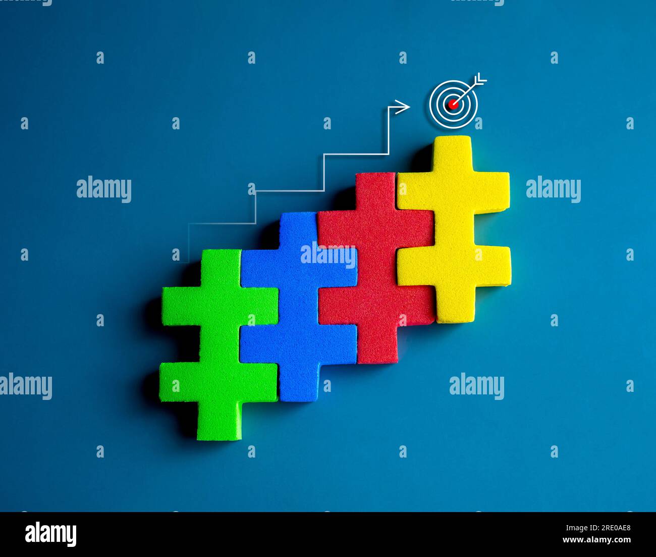 Target icon on top of colorful puzzle blocks bar graph chart steps with ...