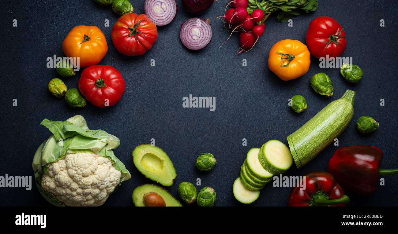 Different fresh various vegetables, cut zucchini, greenery on rustic ...