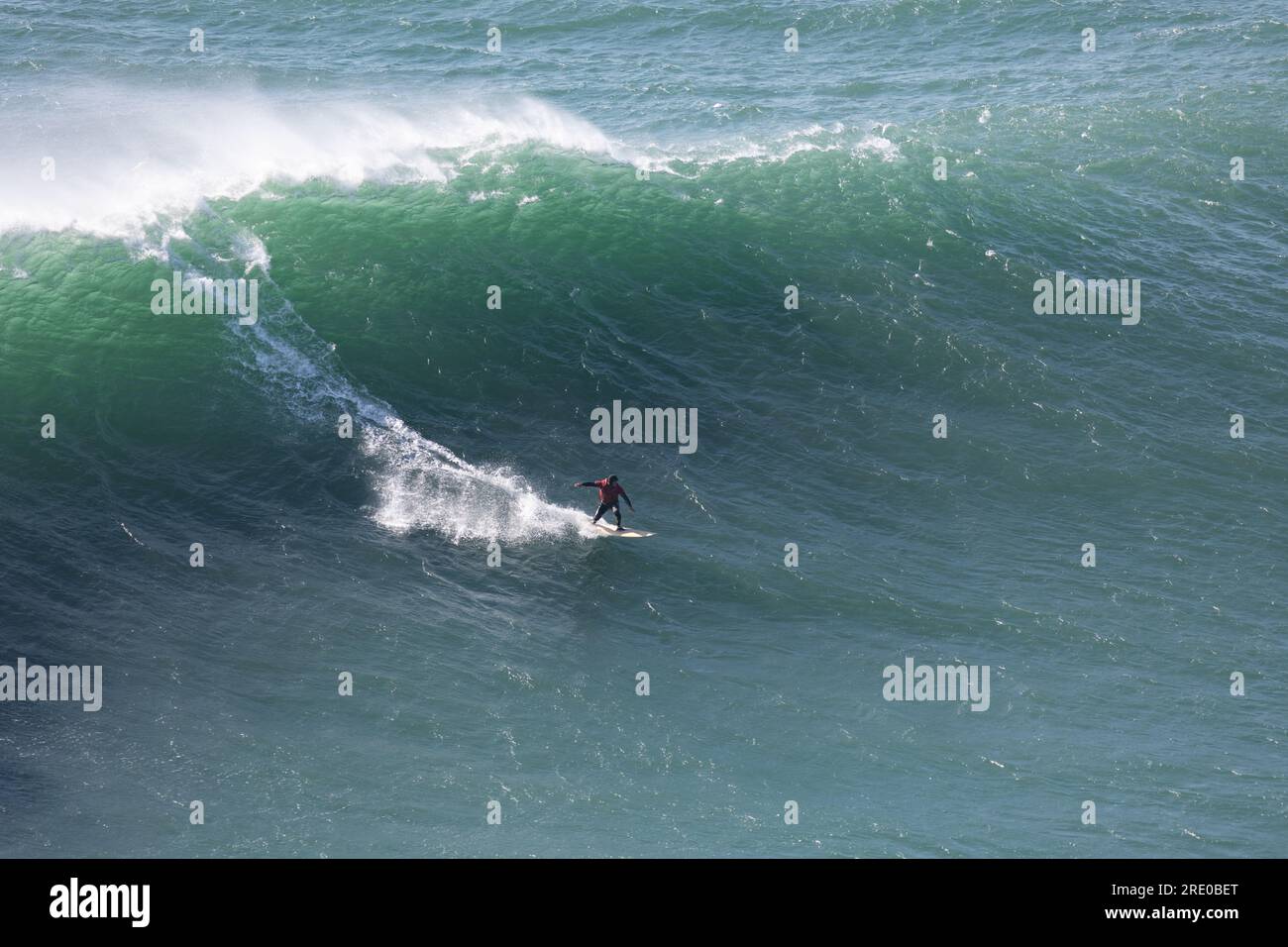 Surfers ride on large sea waves Stock Photo - Alamy