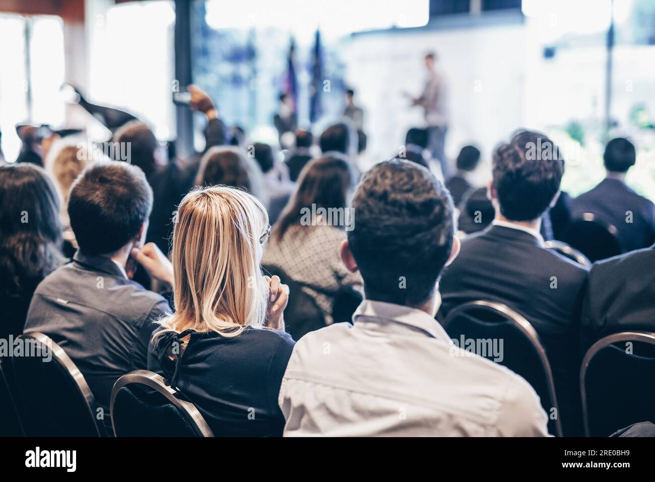 Speaker giving a talk in conference hall at business event. Rear view ...