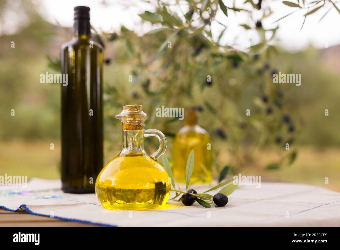 still life of olives and oil on a table against a background of olive ...