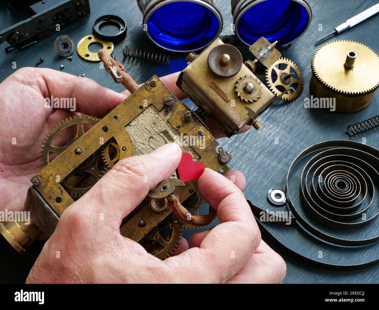 Hands of the master hold mechanical robot and a heart Stock Photo - Alamy