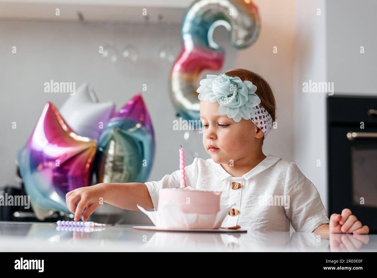 Adorable three year old kid celebrating his birthday and blowing ...
