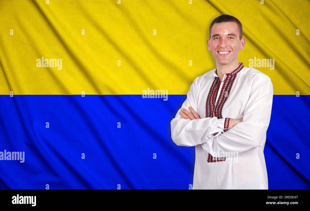 man in Ukrainian embroidered shirt on flag background Stock Photo - Alamy