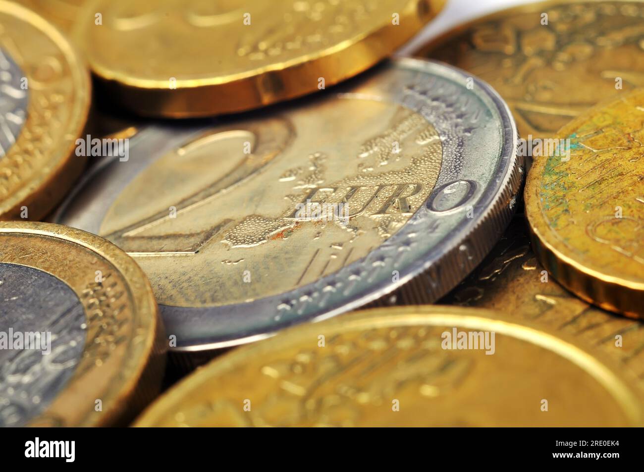 Two Euro coin and many coins, close up Stock Photo - Alamy