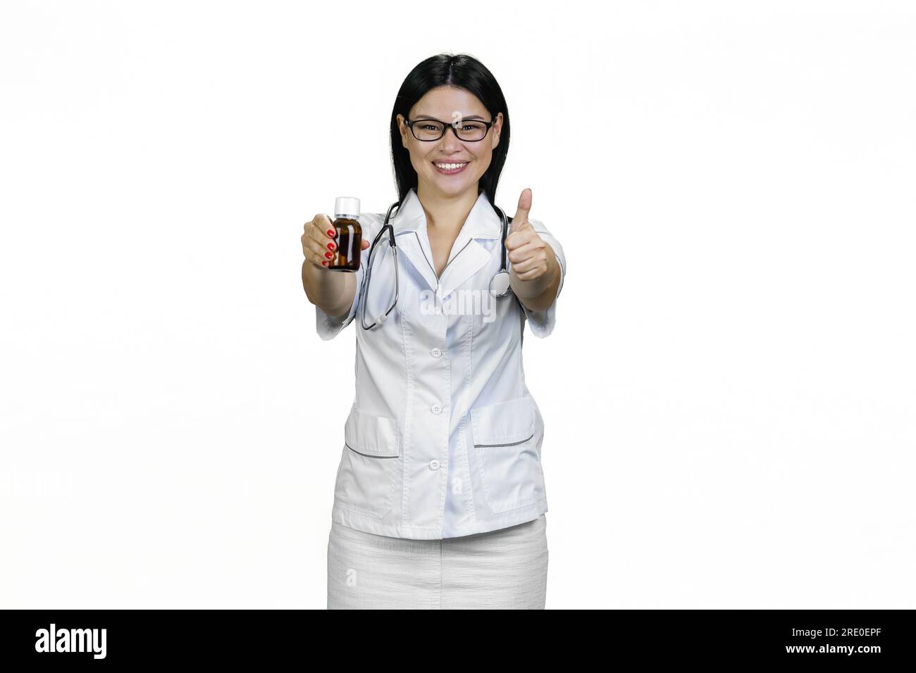Portrait of asian female smiling doctor with syrup bottle giving a ...