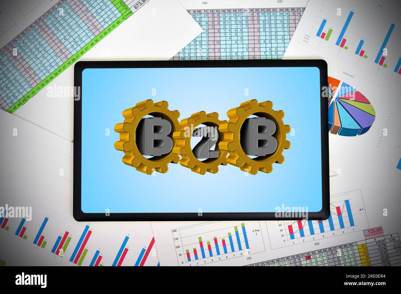 tablet with b2b concept and financial statements on table Stock Photo ...