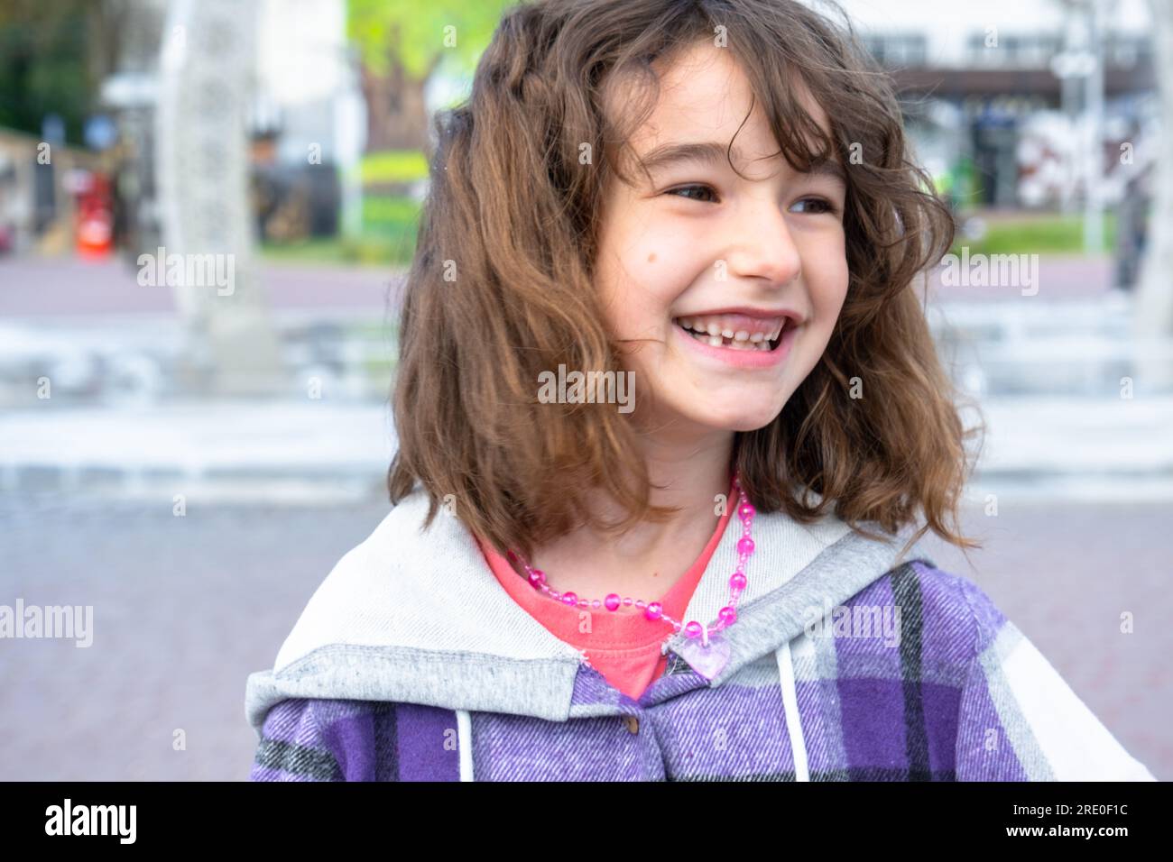 Toothless happy smile of a girl with a fallen lower milk tooth close-up ...