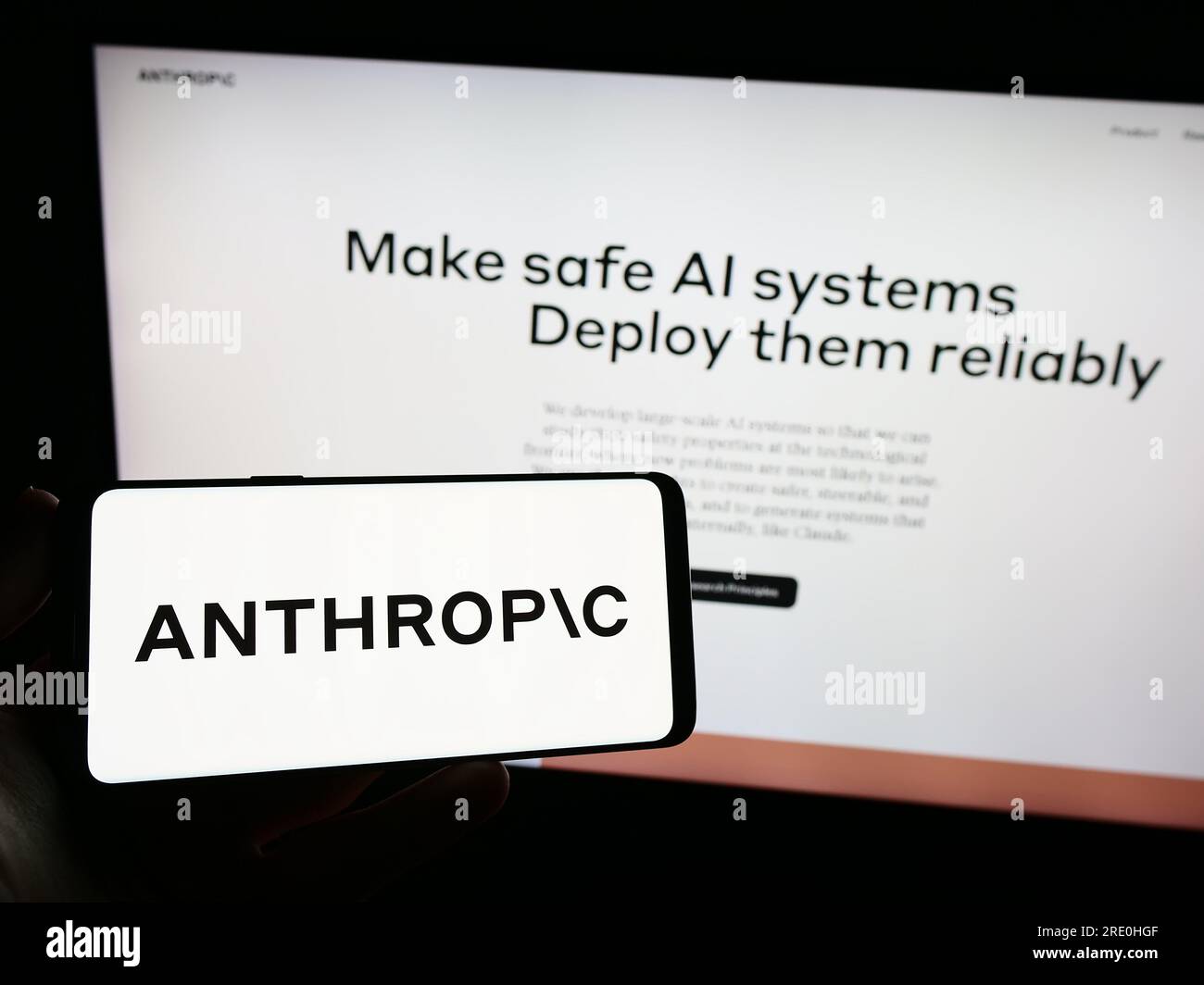 Person holding smartphone with logo of US artificial intelligence ...